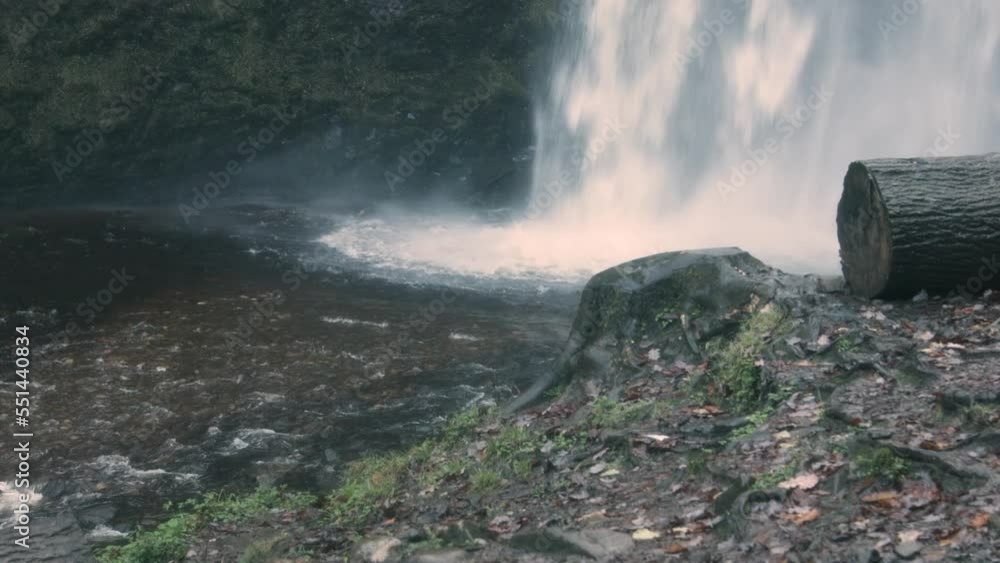 Massive Waterfall Crashing Down with Cut Tree Stump and Logs and River ...