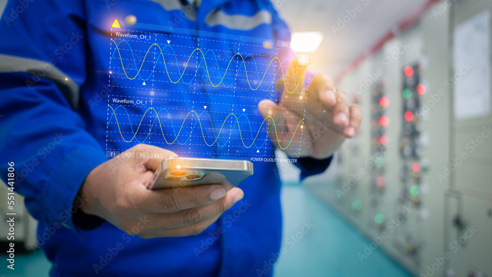Electrical engineer working in substation building checking electrical ...