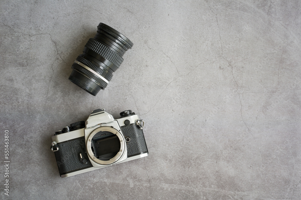 Vintage old camera and lens on cement floor background. Film camera ...