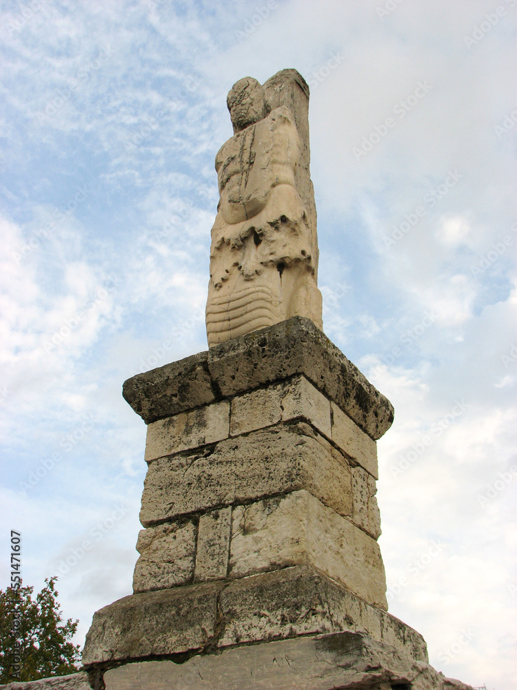 Athens, Greece - An old, crumbling statue along the former facade of ...