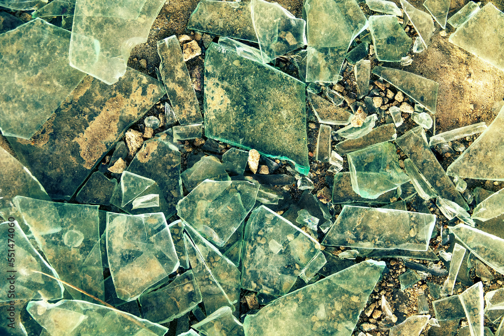 Broken glass on the concrete floor on which they walked with feet ...