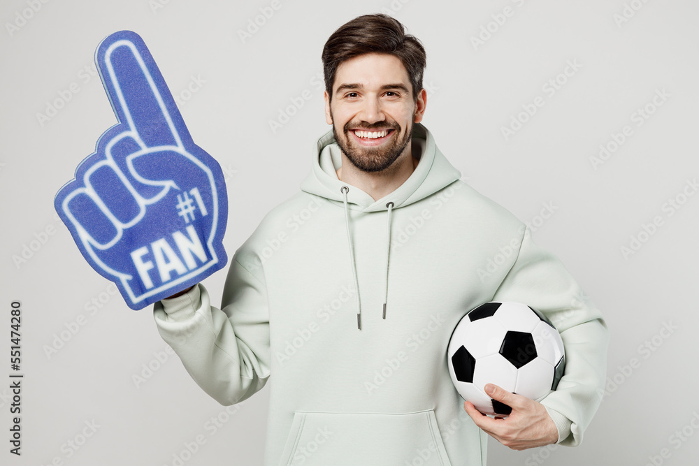 Young smiling fun man fan wear mint hoody foam 1 fan glove finger up ...