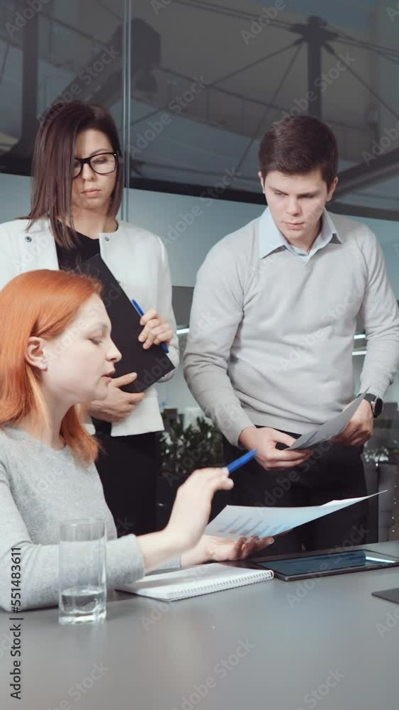 Vertical Screen: Successful team of young business people having ...