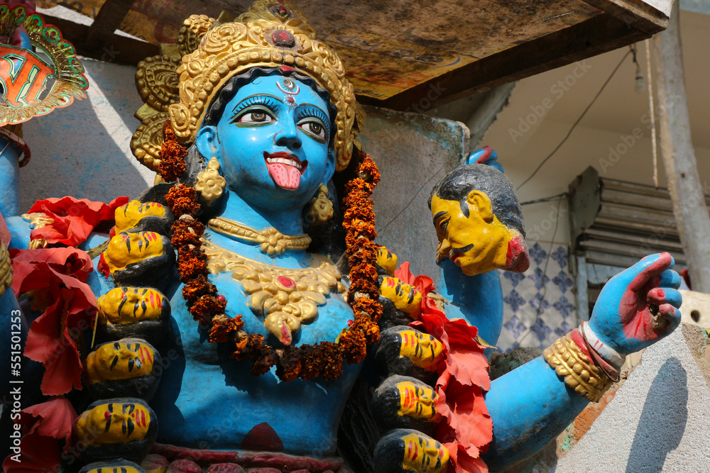 The many-armed goddess Kali with a severed head in her hands and a ...