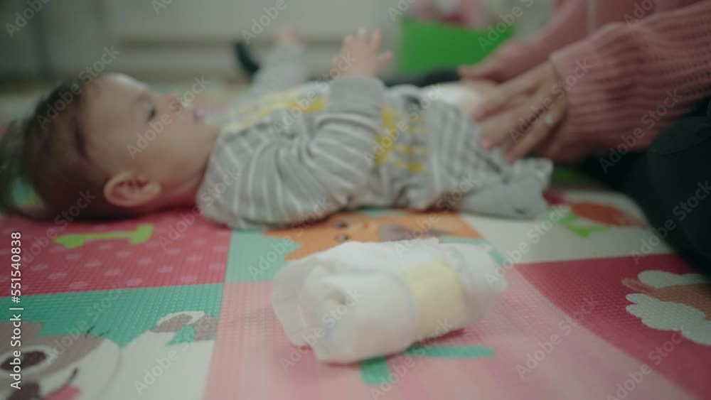 Vidéo Stock Changing diapers - Slow motion of a baby girl lying on the ...