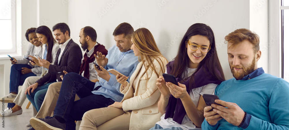 Young people using smartphones. Group of different happy millennial men ...