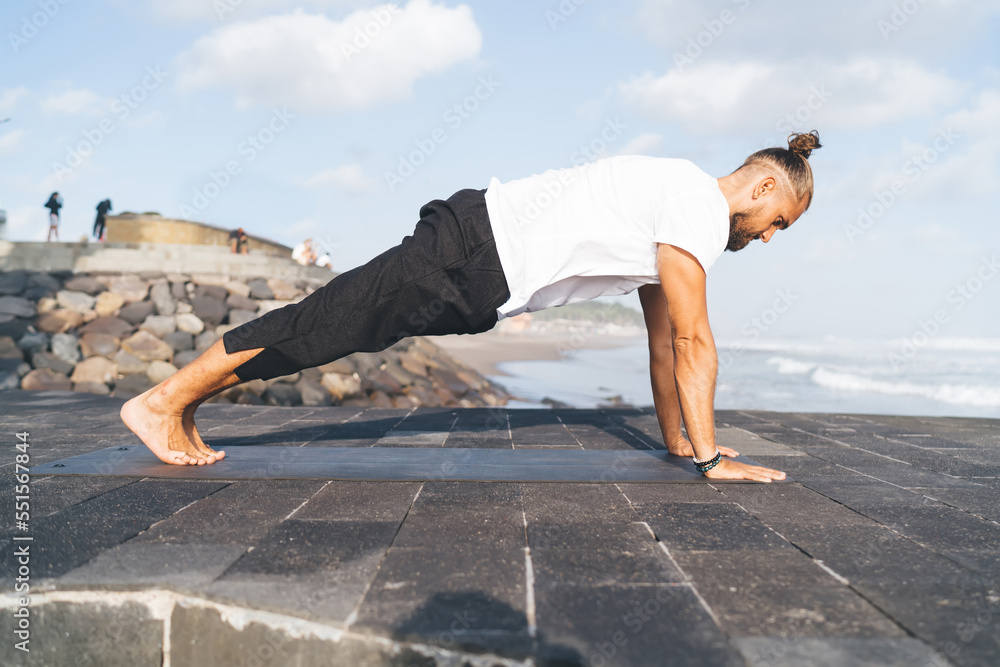 Strong man improving posture with Sun Salutation in morning sun time ...