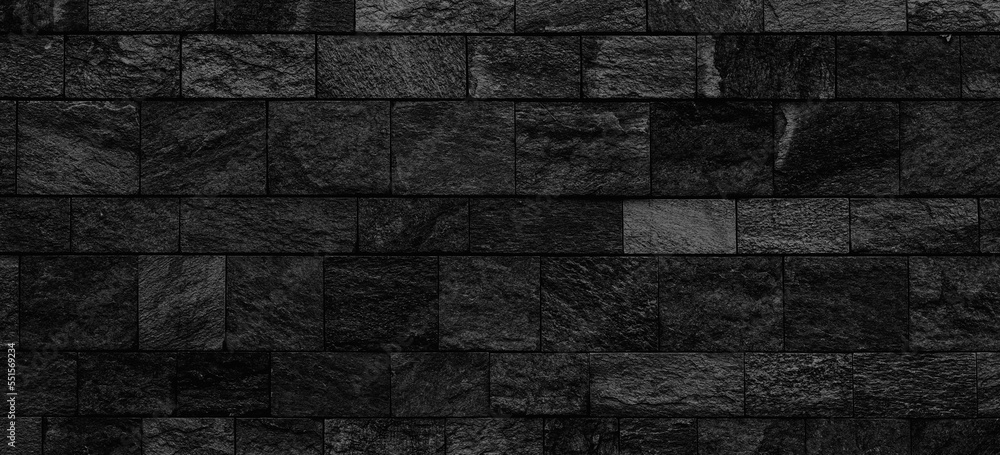 Dark and scary black stone wall background. Panoramic view of a wide ...