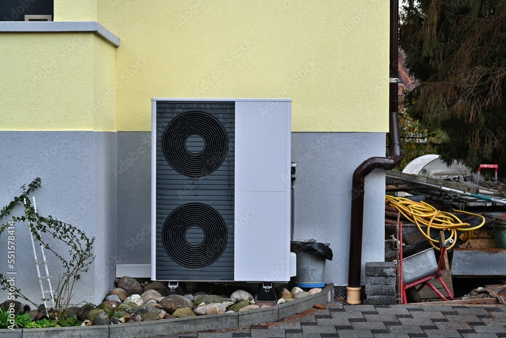 Dark grey colour air source heat pump installed outside the house ...