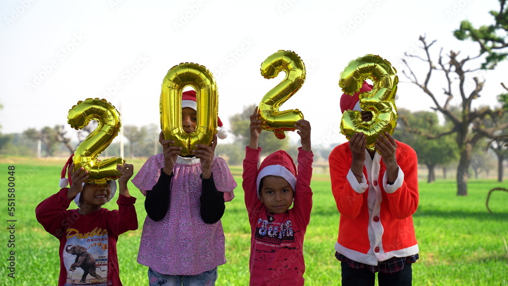Happy children celebrating New Years Eve at garden, holding sparklers ...