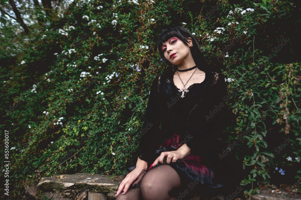 Young and skinny hispanic goth girl with black dress and red skirt ...