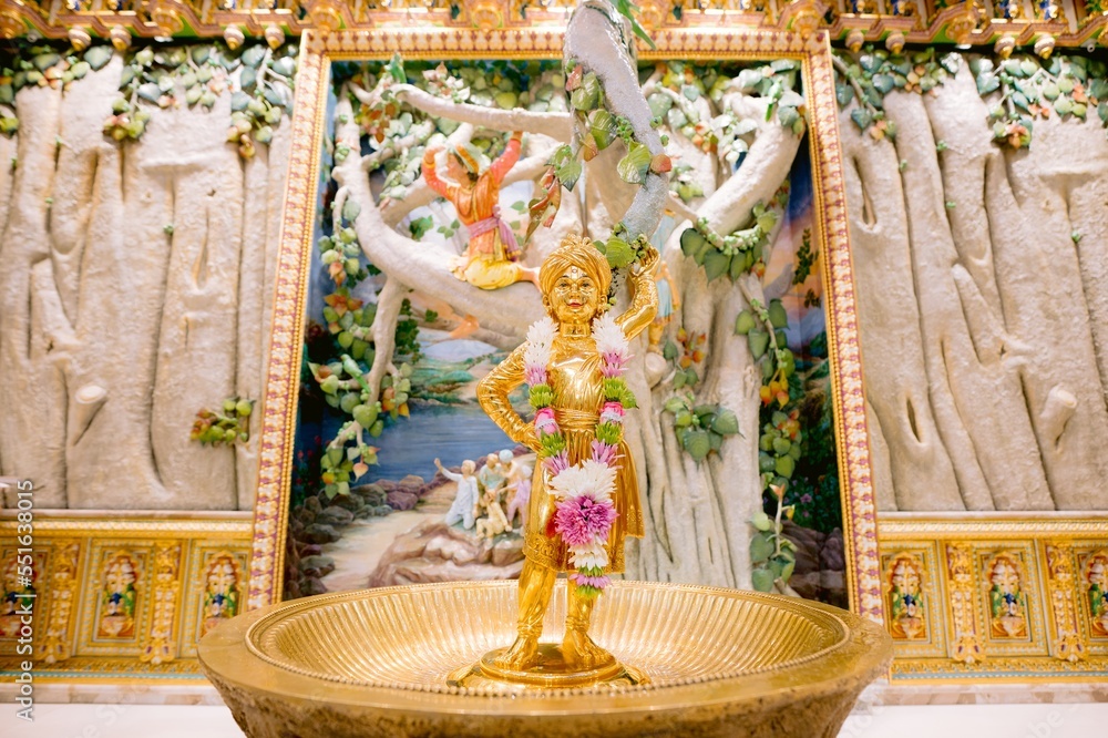 Miniature golden person statue. Small buddhist temple shrine, colorful ...