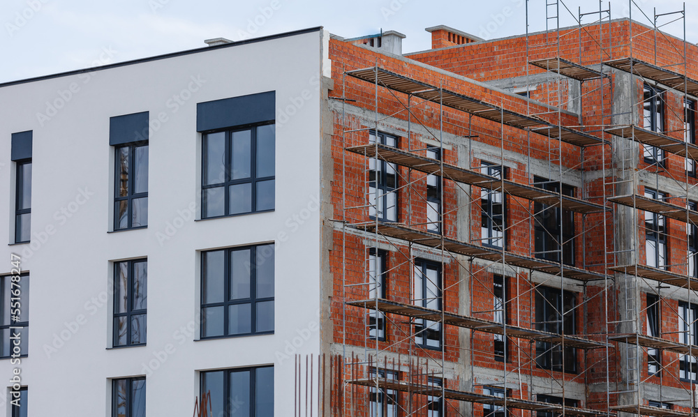 Construction, brick high-rise building. New building. Half of the house ...