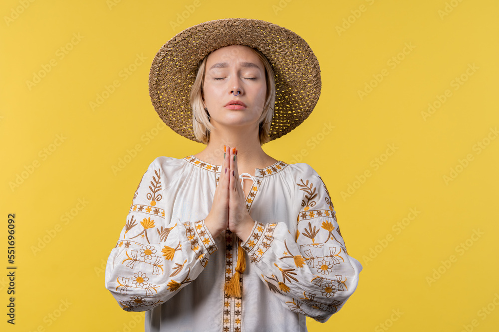 Ukrainian woman praying for Ukraine, victory, peace on yellow ...