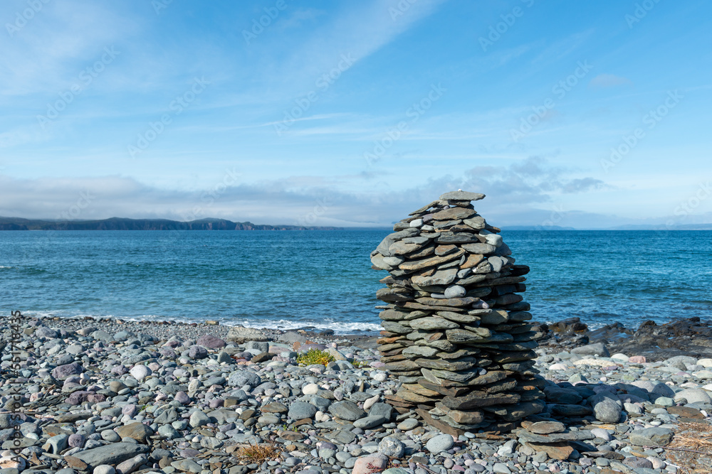 A traditional trail marker called a cairn. The large mass of rocks is ...