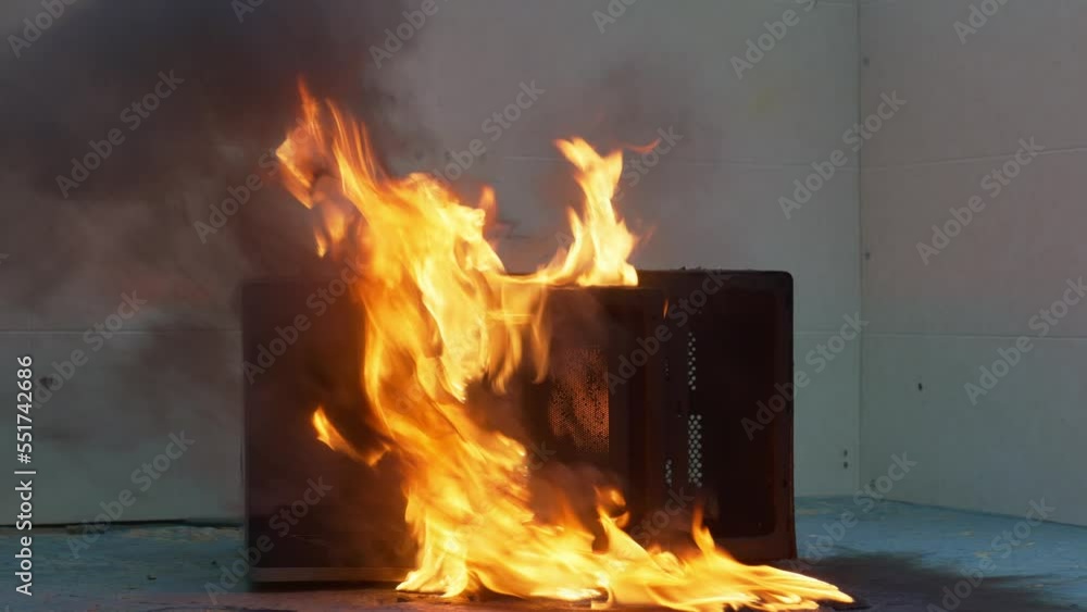 microwave oven on fire. the concept of fire in the kitchen and ...