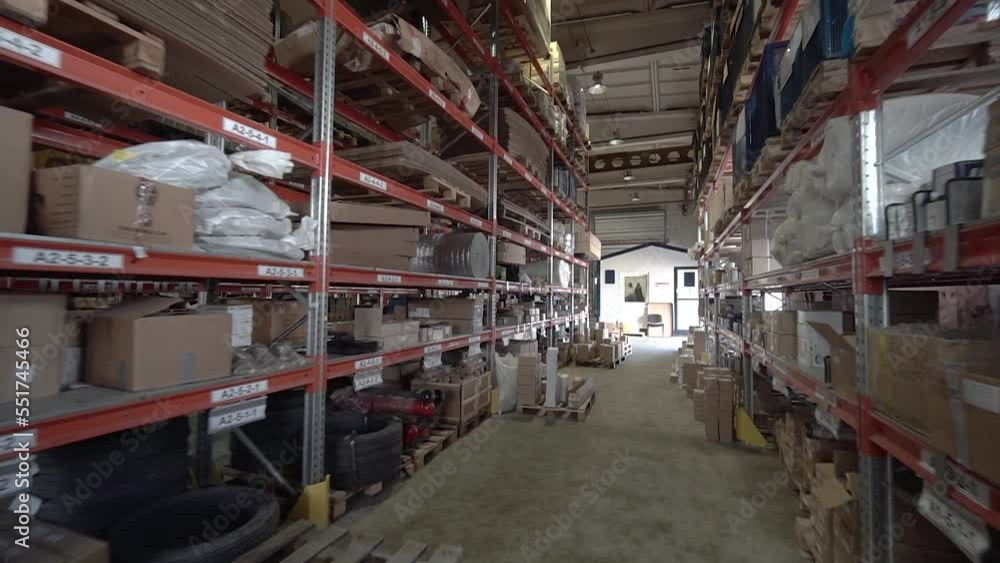 large factory warehouse. store aisles. The camera pans between shelves ...