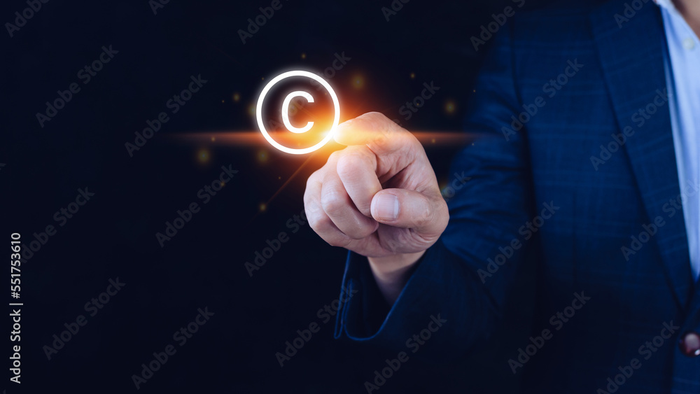 Businessman touching Copyright icon, patents and intellectual property ...