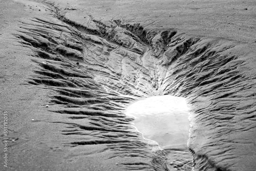 Sand structures with trickles and small creeks and puddle at low tide ...