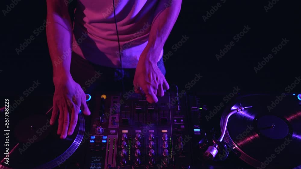 Hip hop DJ scratching vinyl disc on turntable. Club disc jockey plays ...