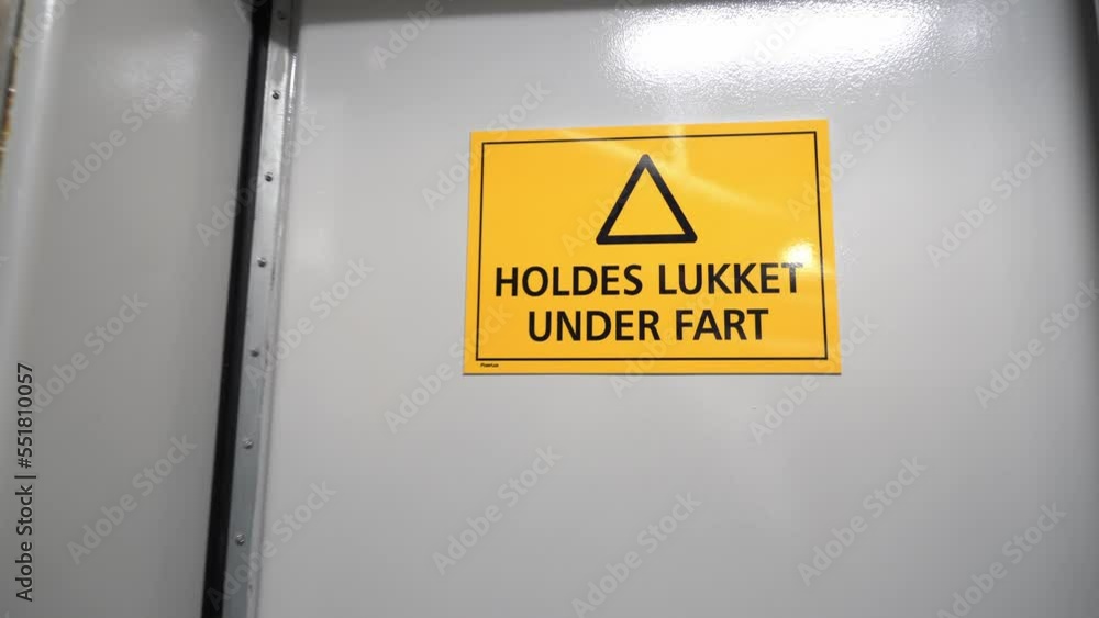 Sign on watertight door in ships engine room warning that door should ...