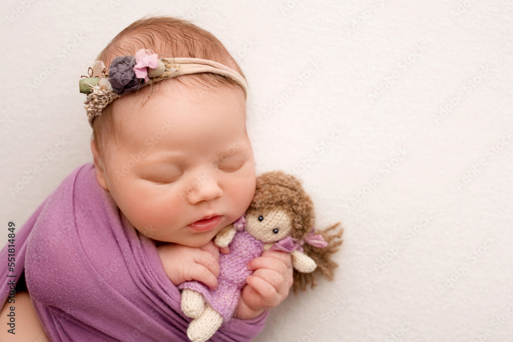 Sleeping newborn girl in the first days of life on a white background ...