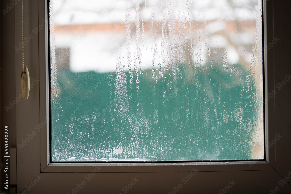 Condensation droplets on plastic window glass from temperature changes ...