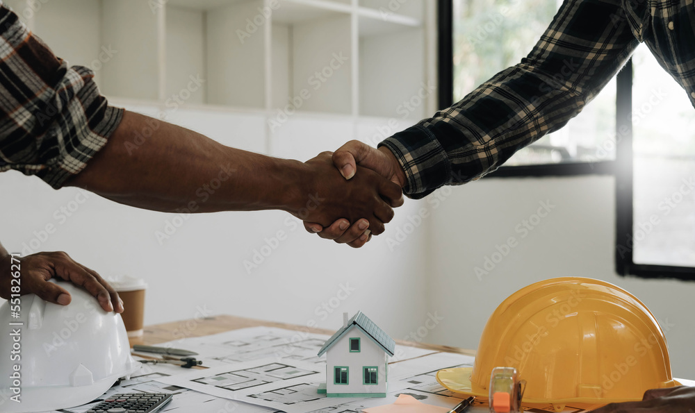 Engineers or architecture shaking hands at construction site for ...