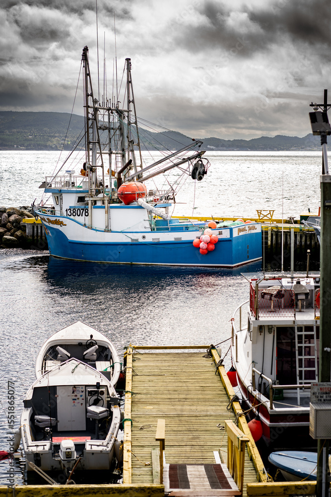 Harbour view of a small tourist destination with a fishing trawler at ...