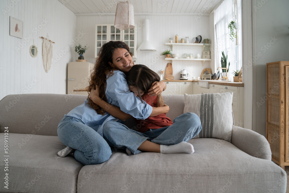 Teen girl hugging cuddling happy smiling mother, daughter showing love ...