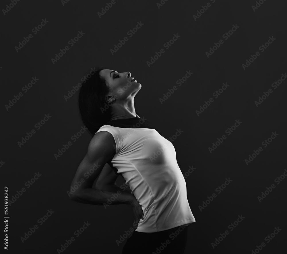 Strong sporty woman doing the arms and shoulders stretching arch ...