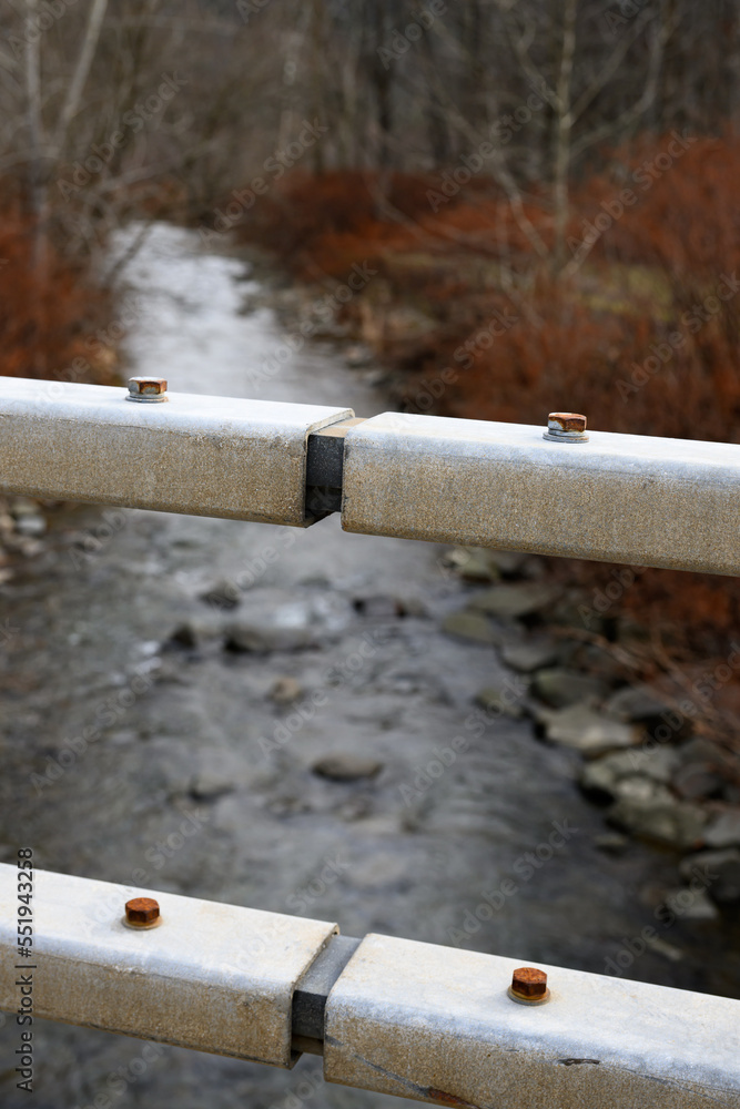 Expansion joints on the guardrails of a small bridge that crosses Sage ...