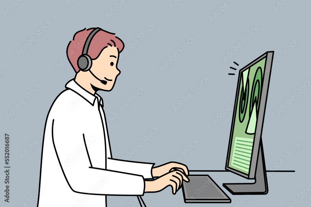 Web designer in headset works at computer. Man programmer in headphones ...