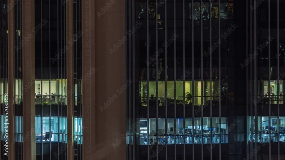 Windows lights in modern office buildings timelapse at night. Multi ...
