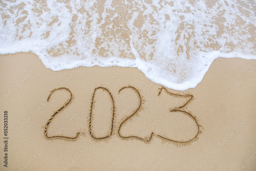 2023 year written on sandy beach sea. Top view. Flat lay. Stock Photo ...