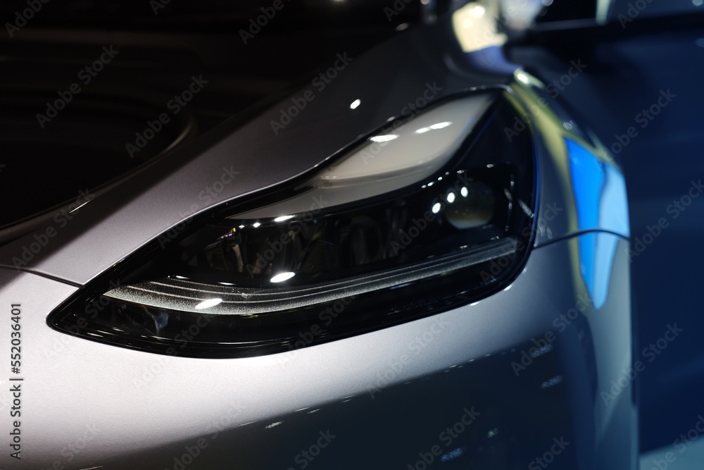 frontal view advanced xenon head-lights of Tesla car model Y in liquid ...