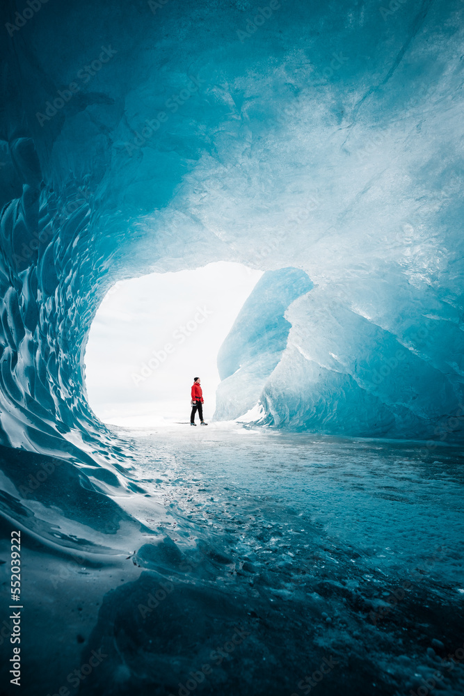 Person is standing in beautiful ice cave in Vatnajkull glacier Iceland ...