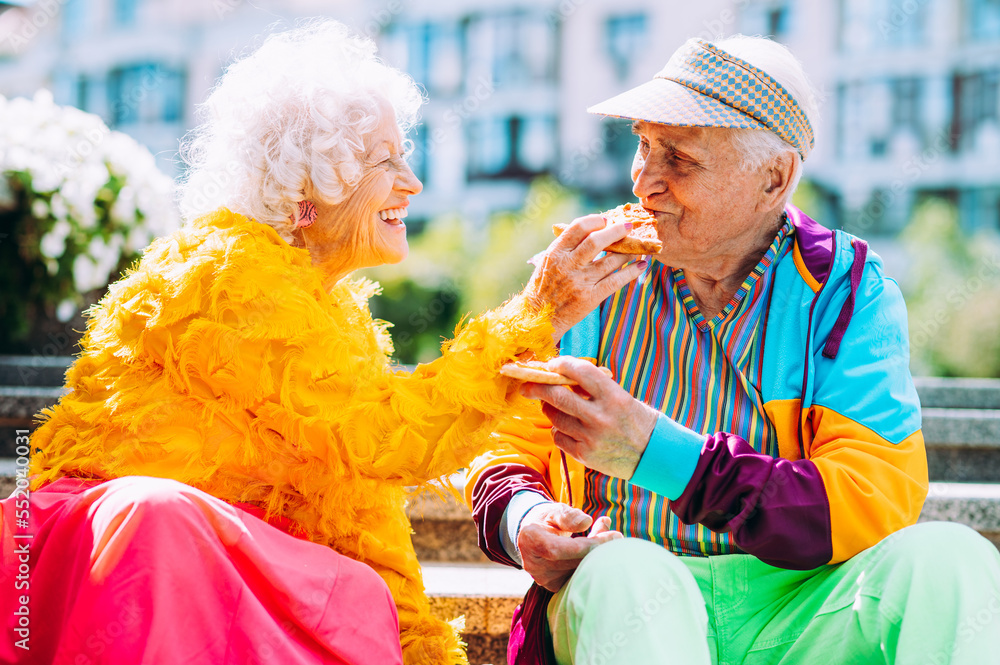 Old modern couple dressing fashionable colored clothes. Youthful ...