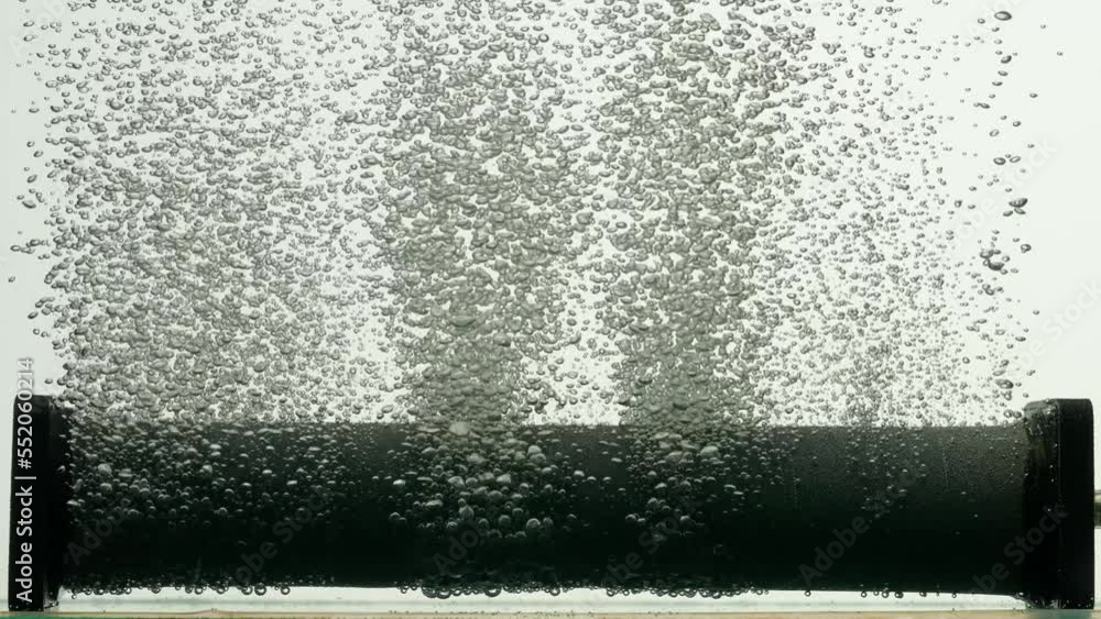 Stream of air bubbles escaping from dark paralon tube of compressor or ...