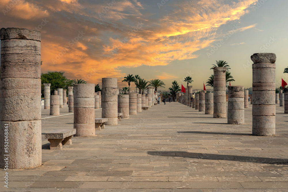 People walking around the medieval columns next to the Hassan tower in ...