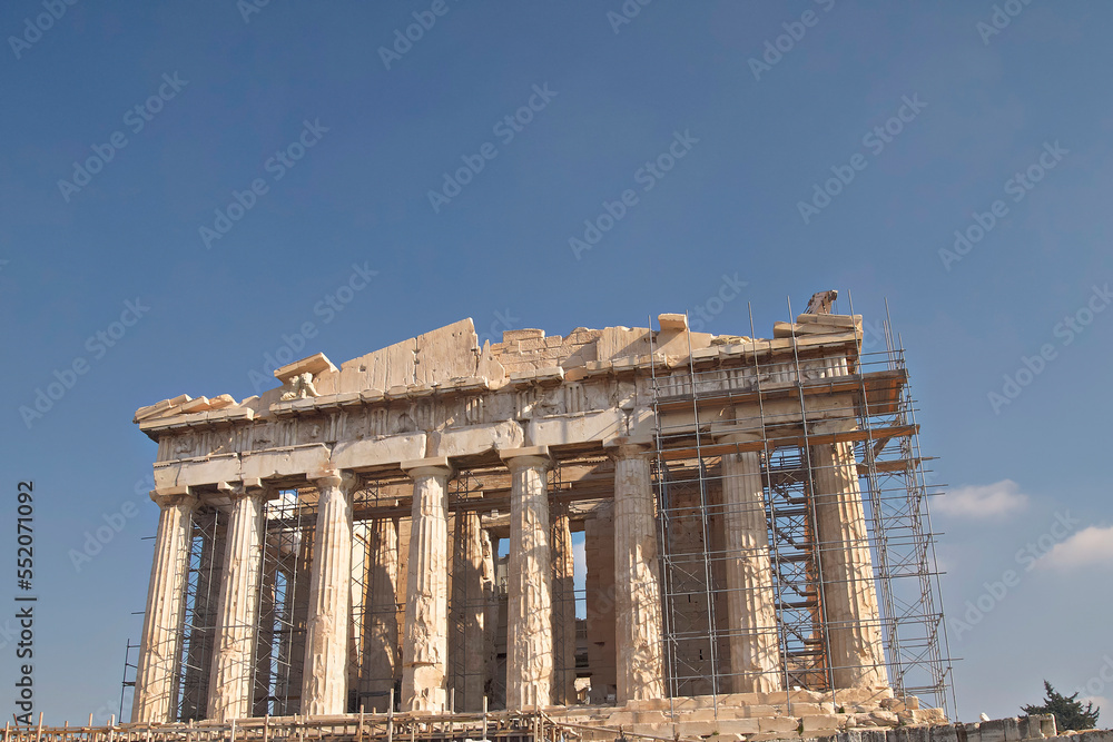 The western main front of Parthenon ancient temple under a clear blue sky as a background. A ...