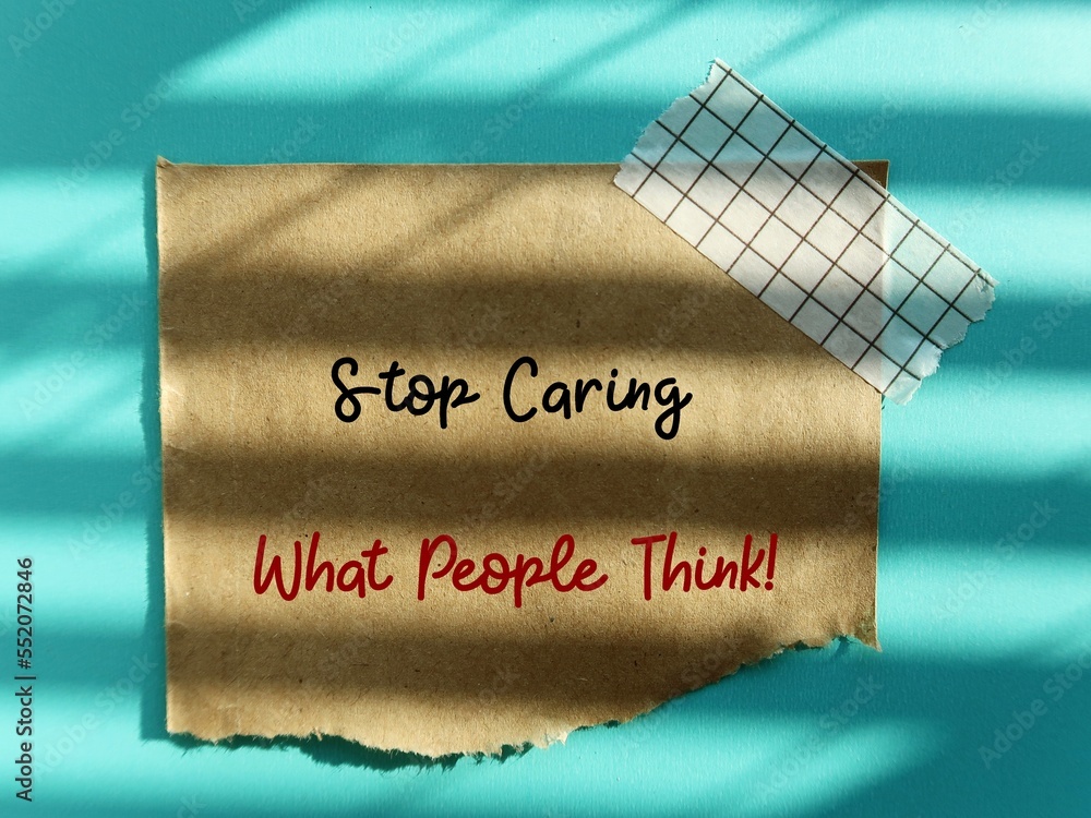 Torn stick note with handwritten text STOP CARING WHAT PEOPLE THINK ...