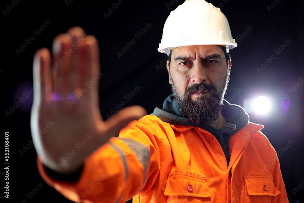 Handsome bearded man wearing worker uniform and hardhat with open hand ...