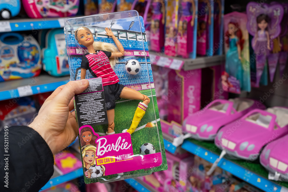 Barbie doll soccer player with a soccer ball in the hand of a customer ...