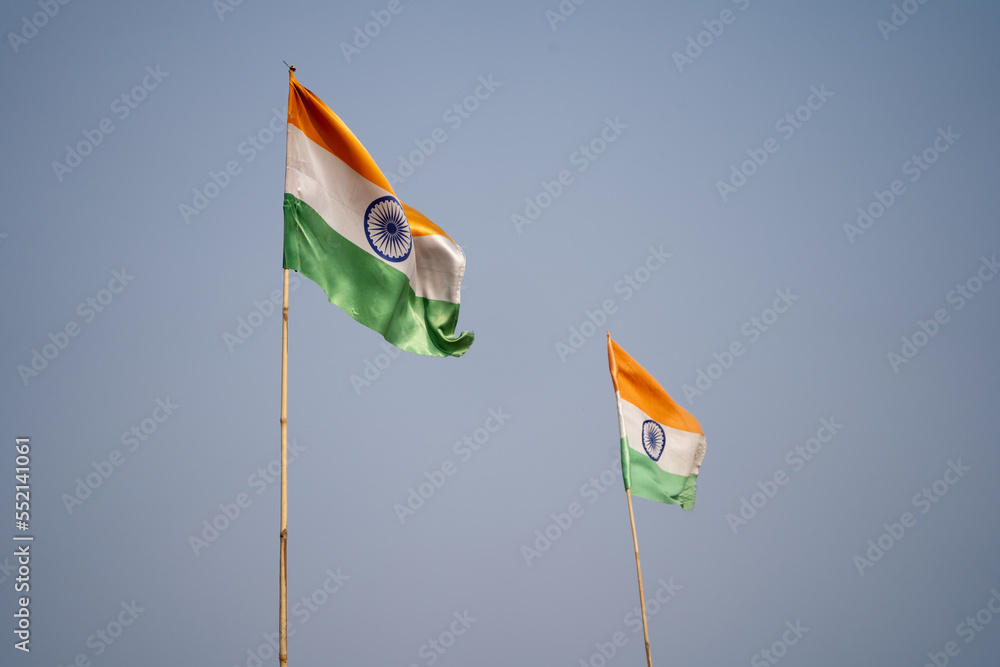 two Indian tri color with saffron green white and ashoka chakra waving ...