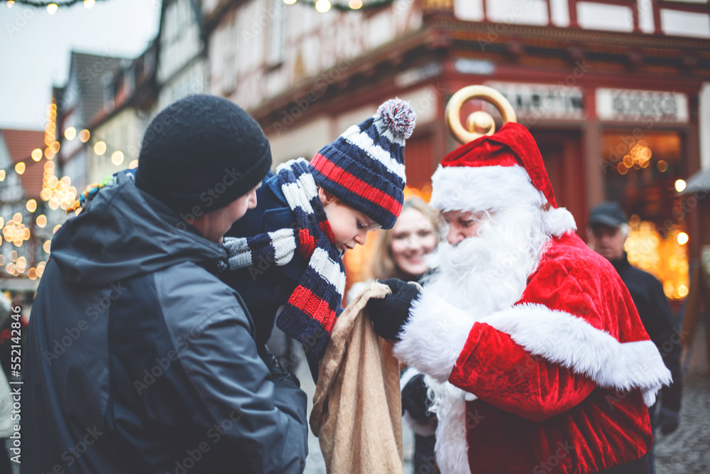 Little toddler boy with father on Christmas market. Happy kid taking ...