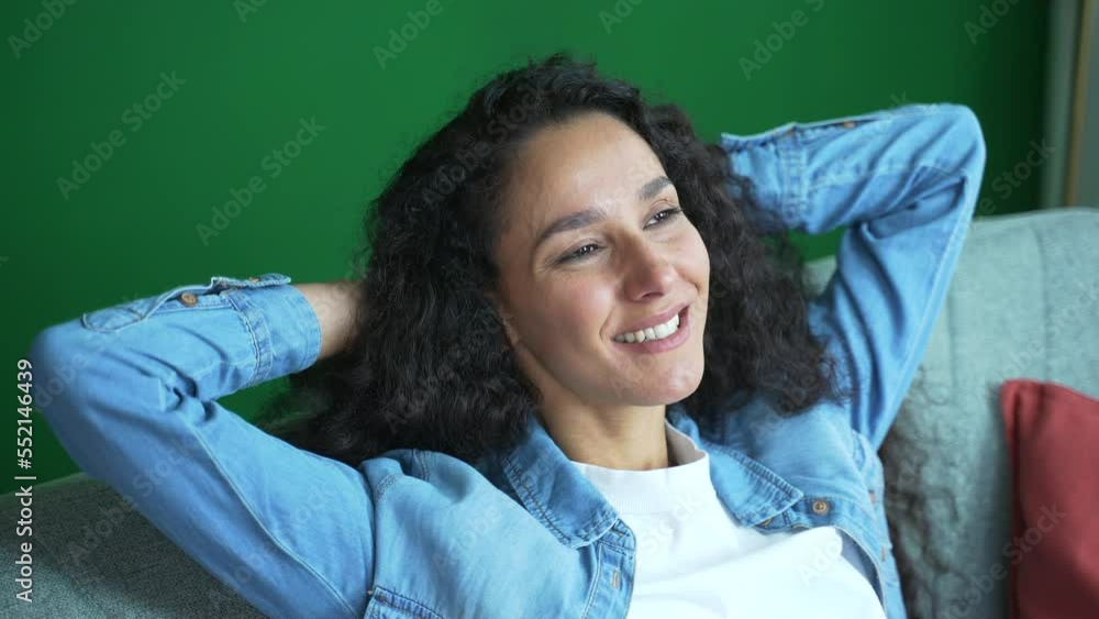 Beautiful dark haired young lady relaxing on comfortable sofa with ...