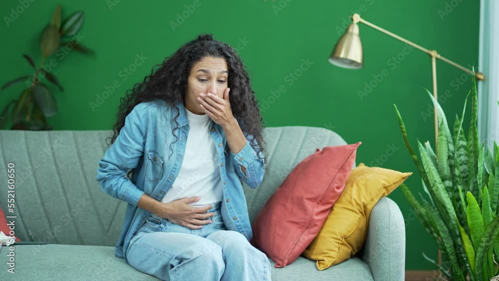Sick young dark haired curly woman suffering from stomach ache feeling ...