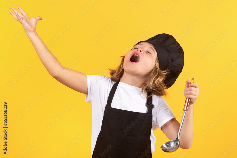 Funny kid chef cook with kitchen ladle, studio portrait. Child in cook ...