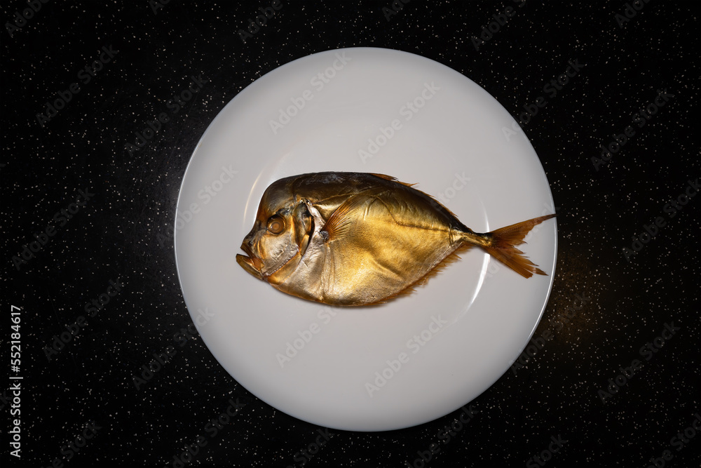 Smoked fish on a white plate. Vomers (Selene peruviana) are a genus of ...